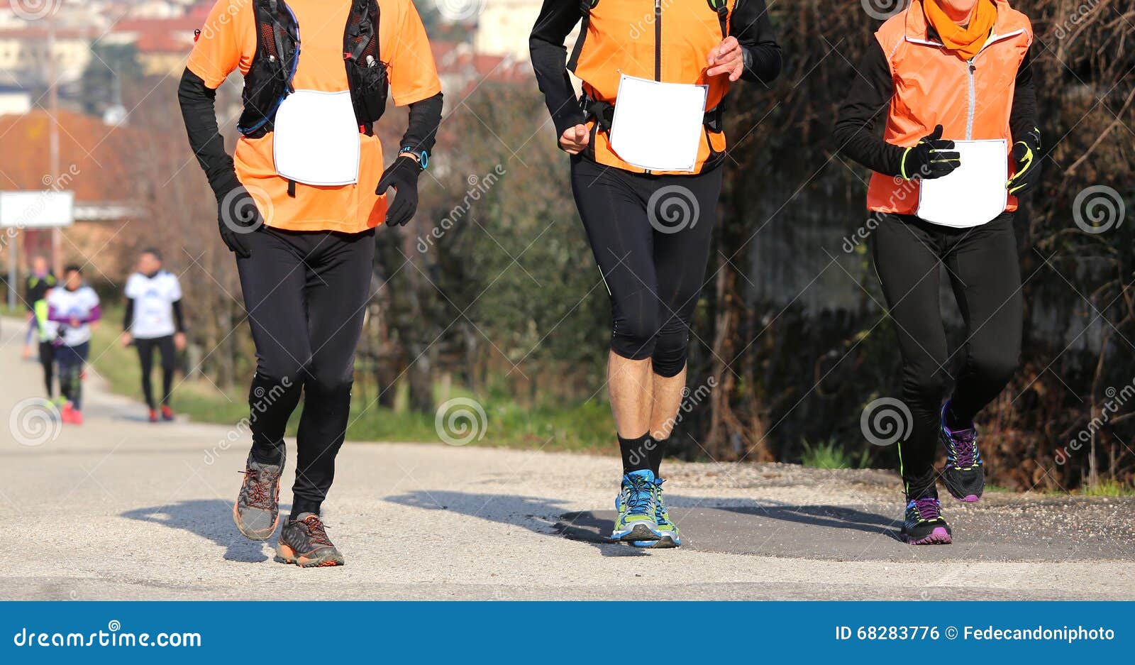 Three Runners Run on Asphalt Road Outdoors Stock Photo - Image of ...