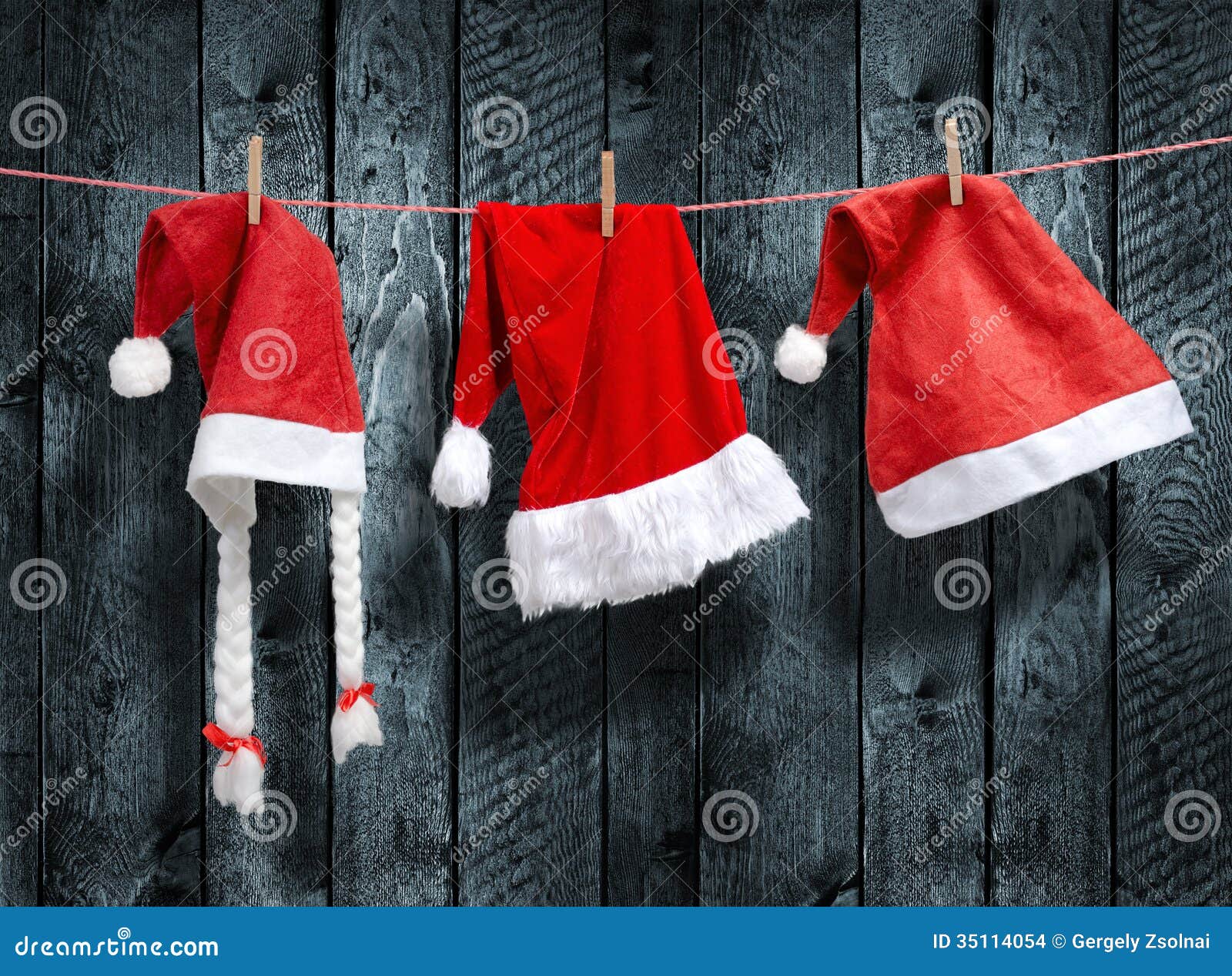 Three Santa Claus Hat Hanging on a Clothesline Stock Photo - Image of ...