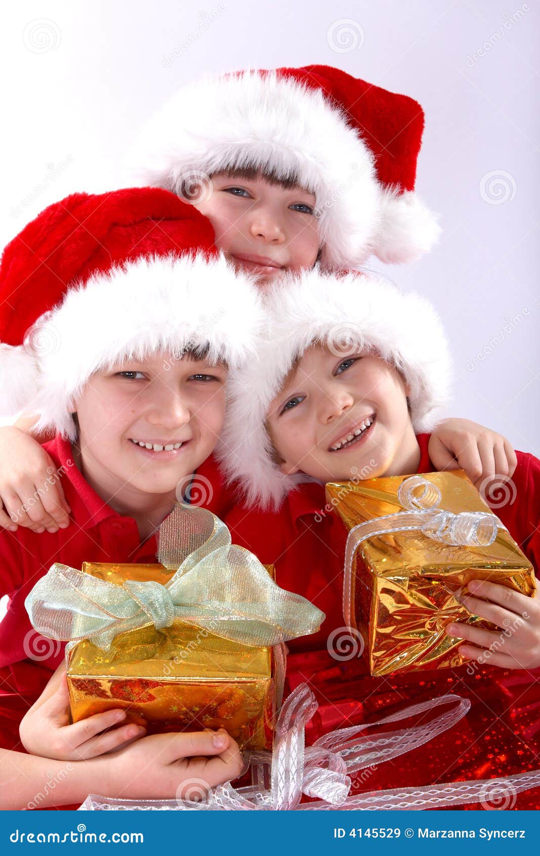 Three Santa Kids with Gifts Stock Image - Image of hats, christmas: 4145529