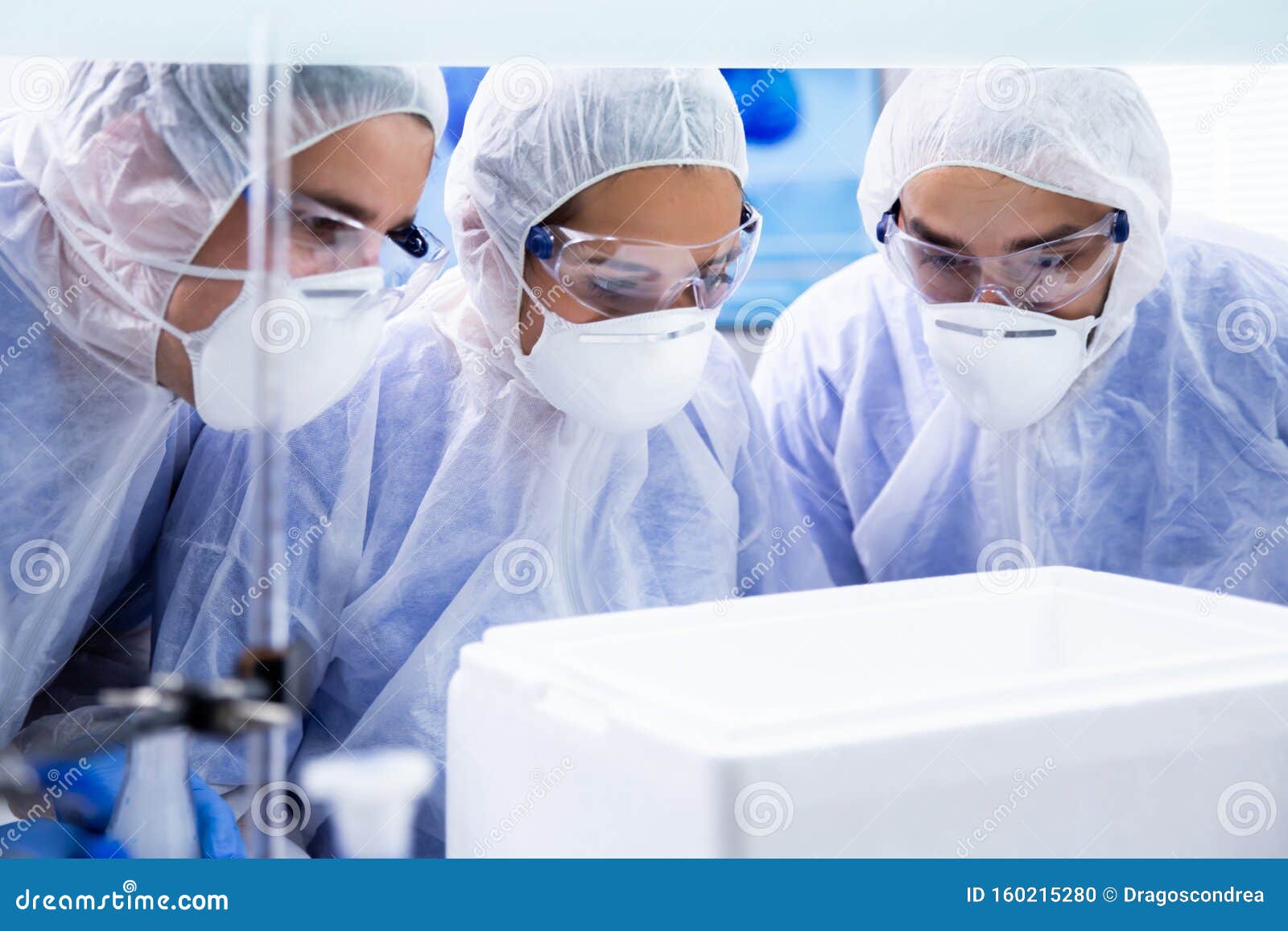 Three Scientists Look at a White Box in the Lab Stock Photo - Image of ...