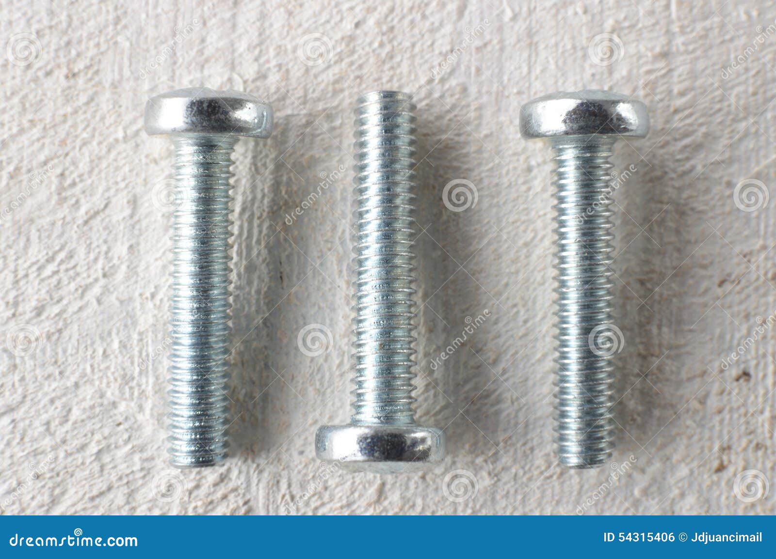 Three Screws on a White Wooden Table Stock Photo - Image of steel ...