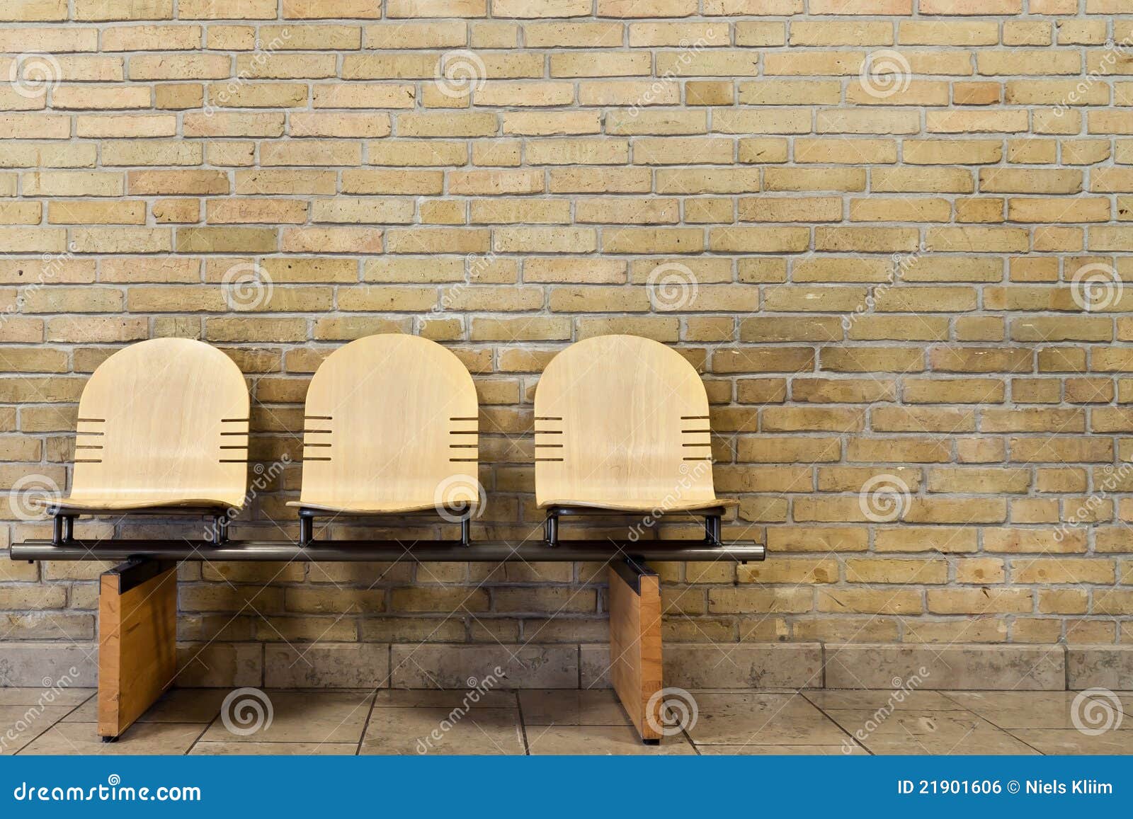 Three Seated Bench Against Yellow Brick Wall Stock Photo - Image of ...