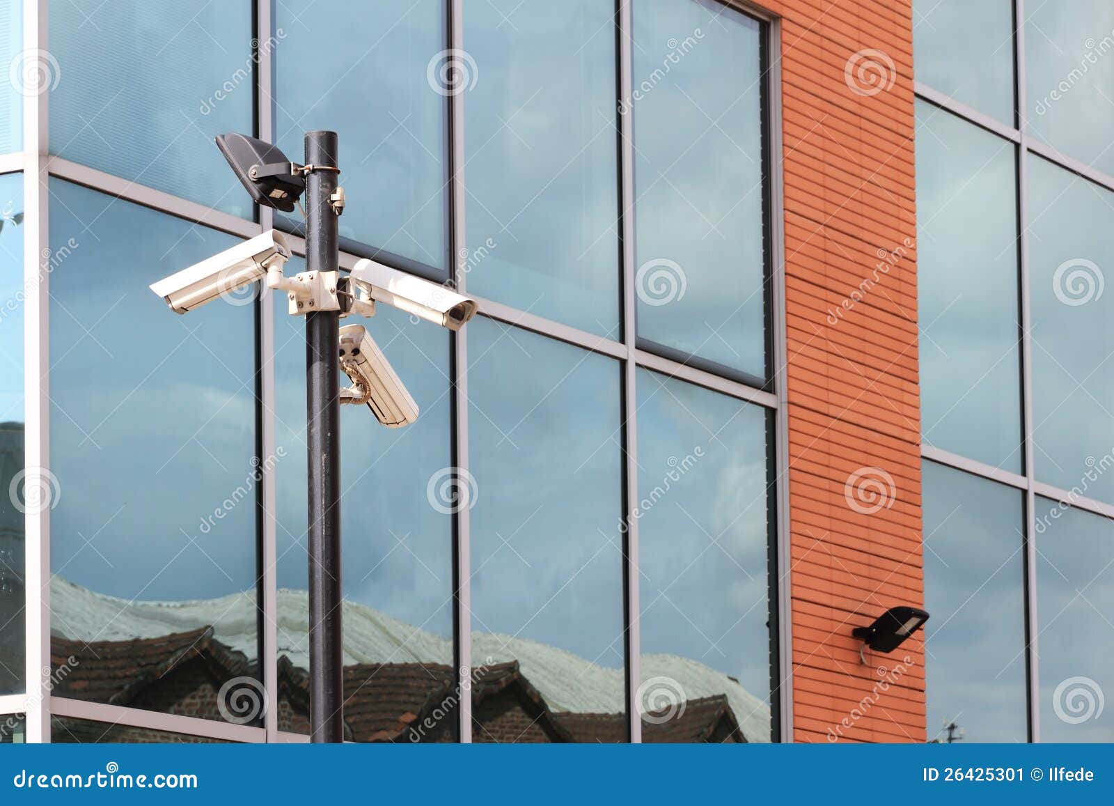 Three Security Cameras on Front of Glass Building Stock Image - Image ...