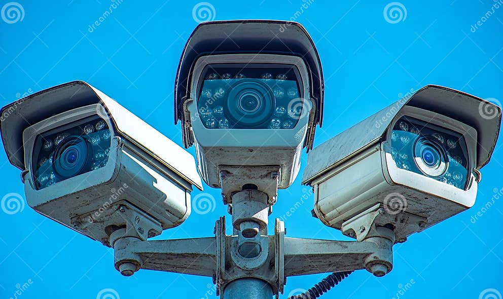 Three Security Cameras are Mounted on a Pole, One of Which is Facing ...