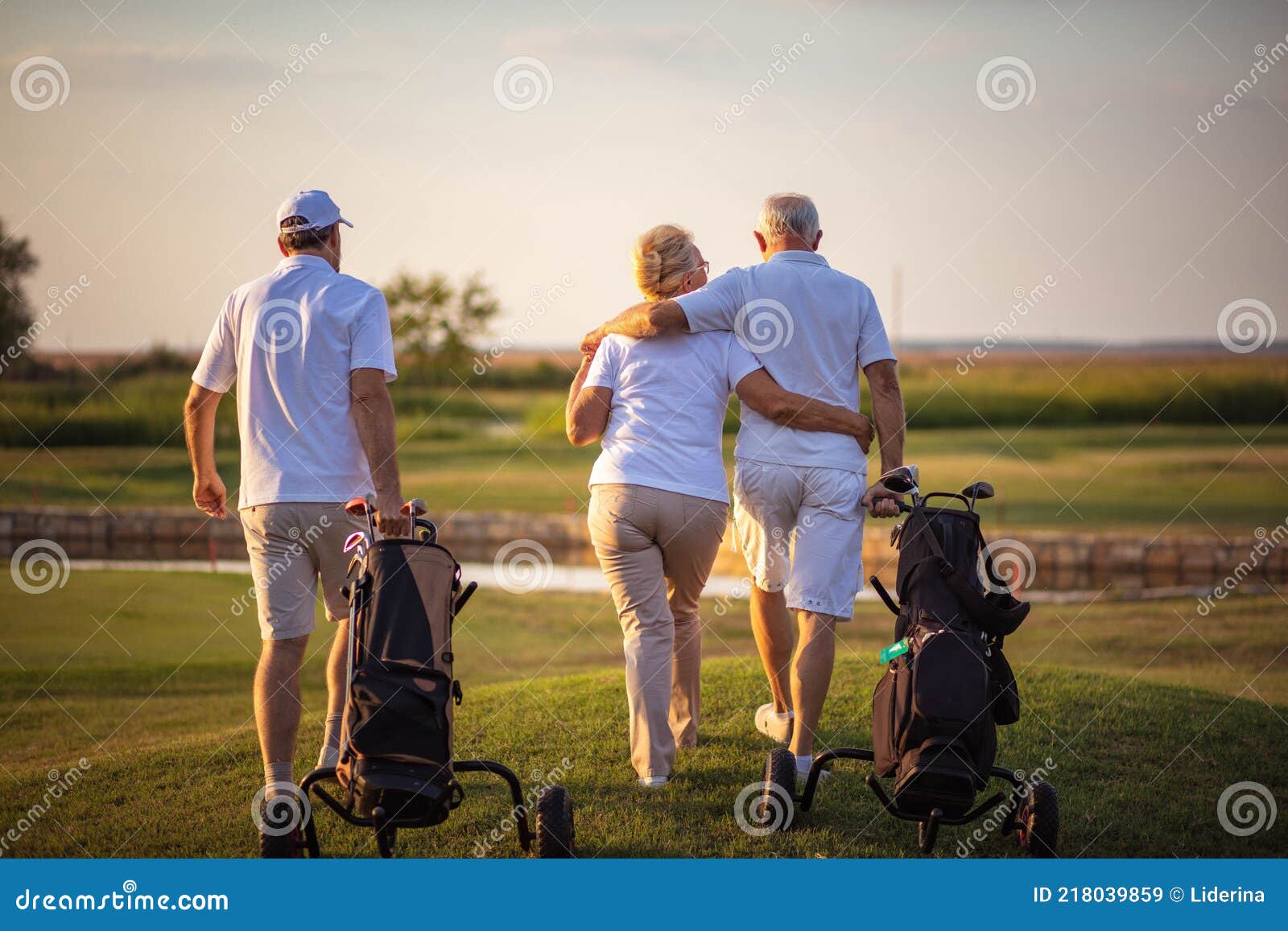 Three Senior Golfers Walking on Golf Court Stock Image - Image of ...