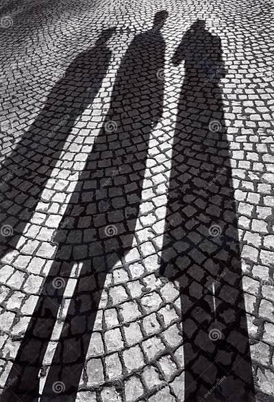 Three shadows stock image. Image of people, street, shadows - 12427625
