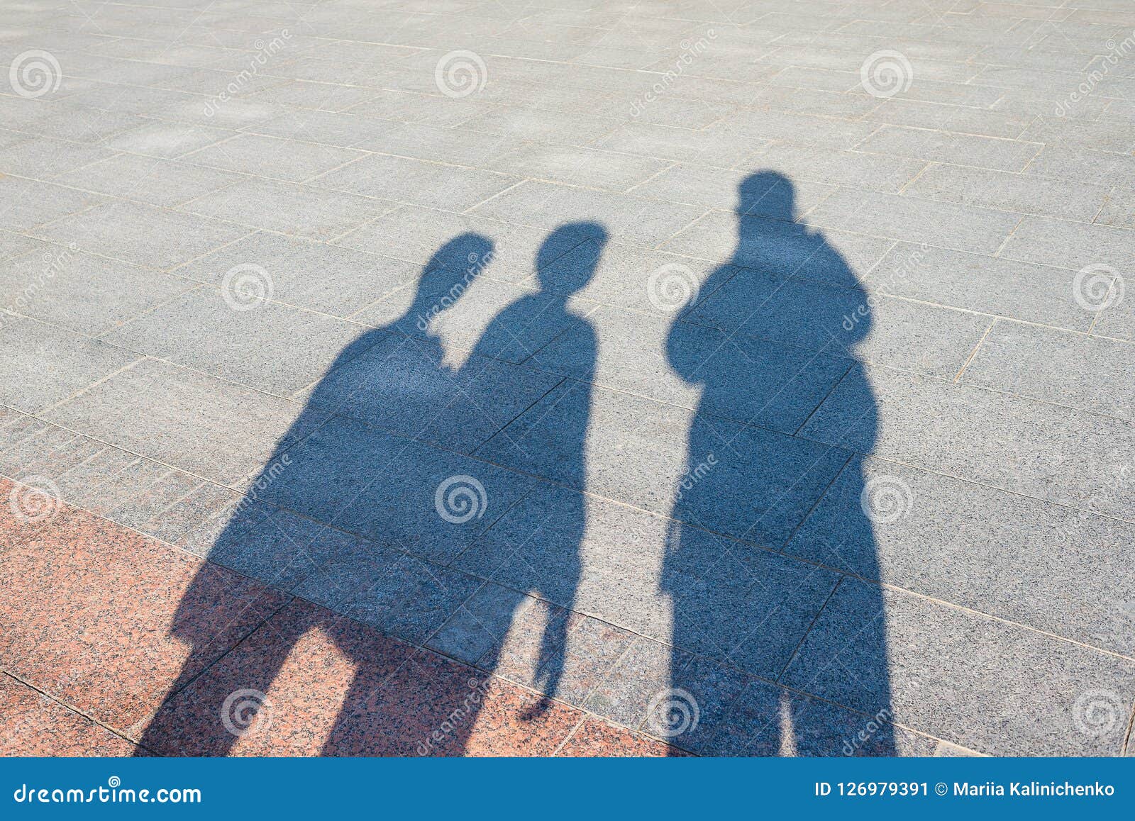 Three Shadows of People on Sidewalk Tile Stock Image - Image of shadows ...
