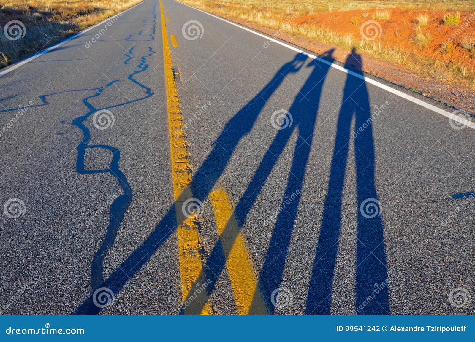 Three shadows on the road. stock photo. Image of roadtrip - 99541242