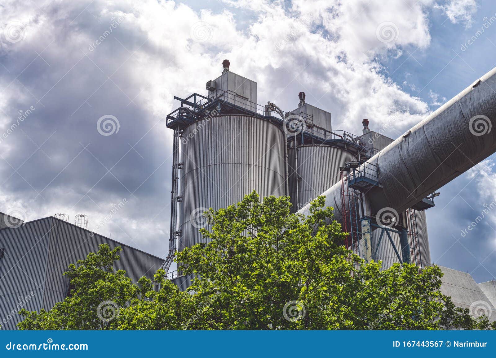 Three Silos and a Large Pipe of a Factory Stock Image - Image of ...
