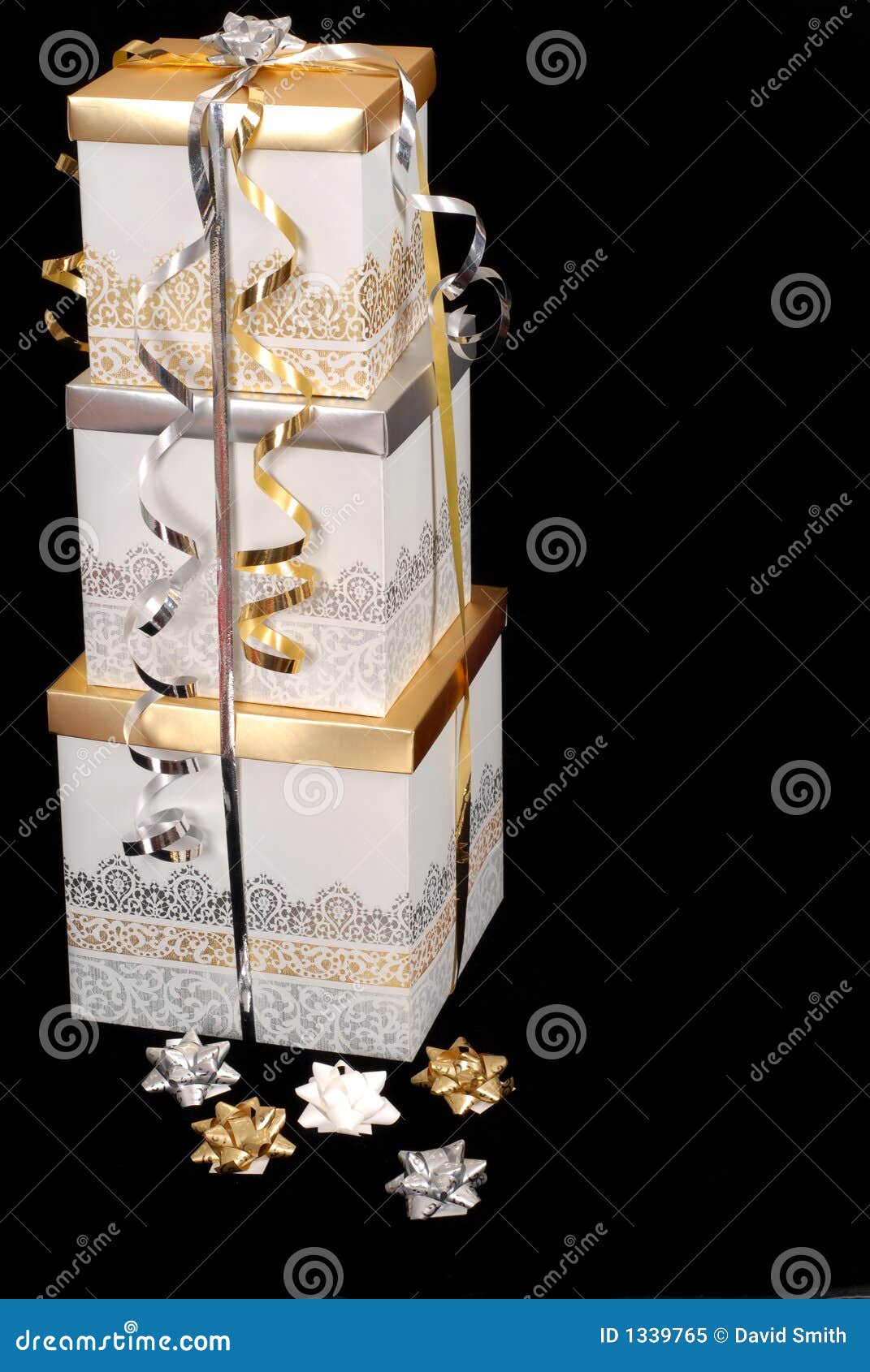 Three Silver and Gold Wrapped Christmas Presents with Bows Stock Image ...