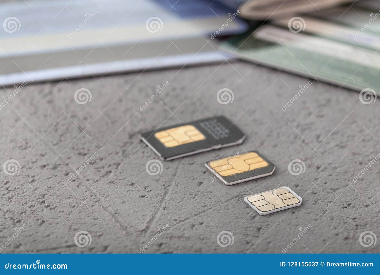 Three SIM Cards of Different Sizes Lie on a Rough Surface. Close-up ...