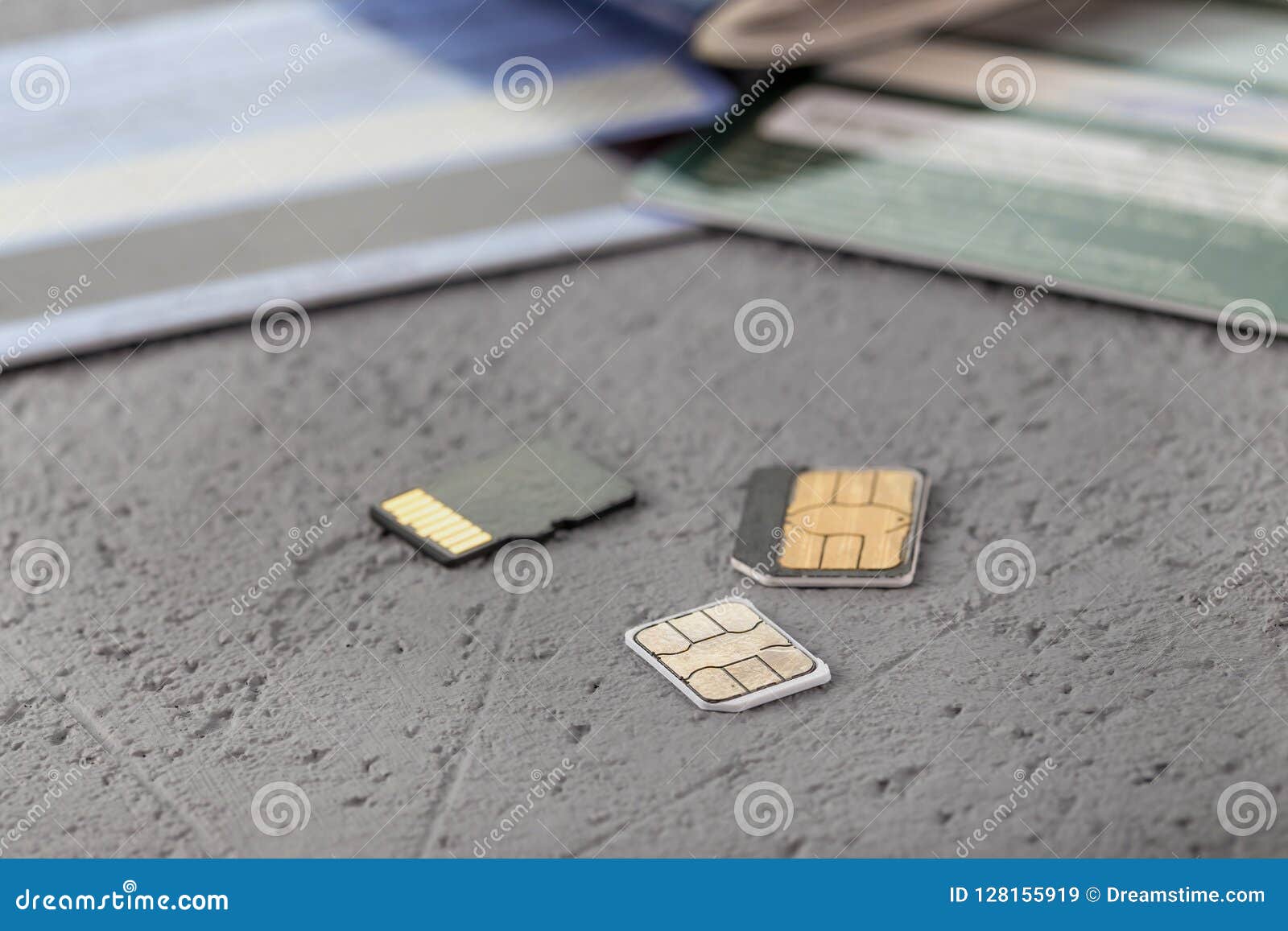 Three SIM Cards of Different Sizes Lie on a Rough Surface. Close-up ...