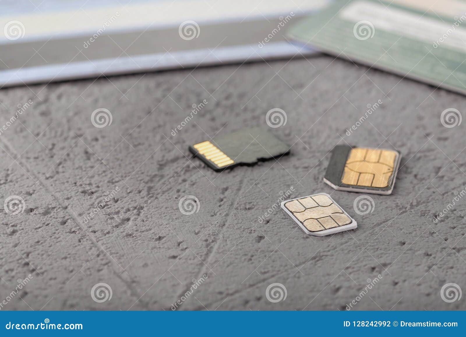 Three SIM Cards of Different Sizes Lie on a Rough Surface. Close-up ...