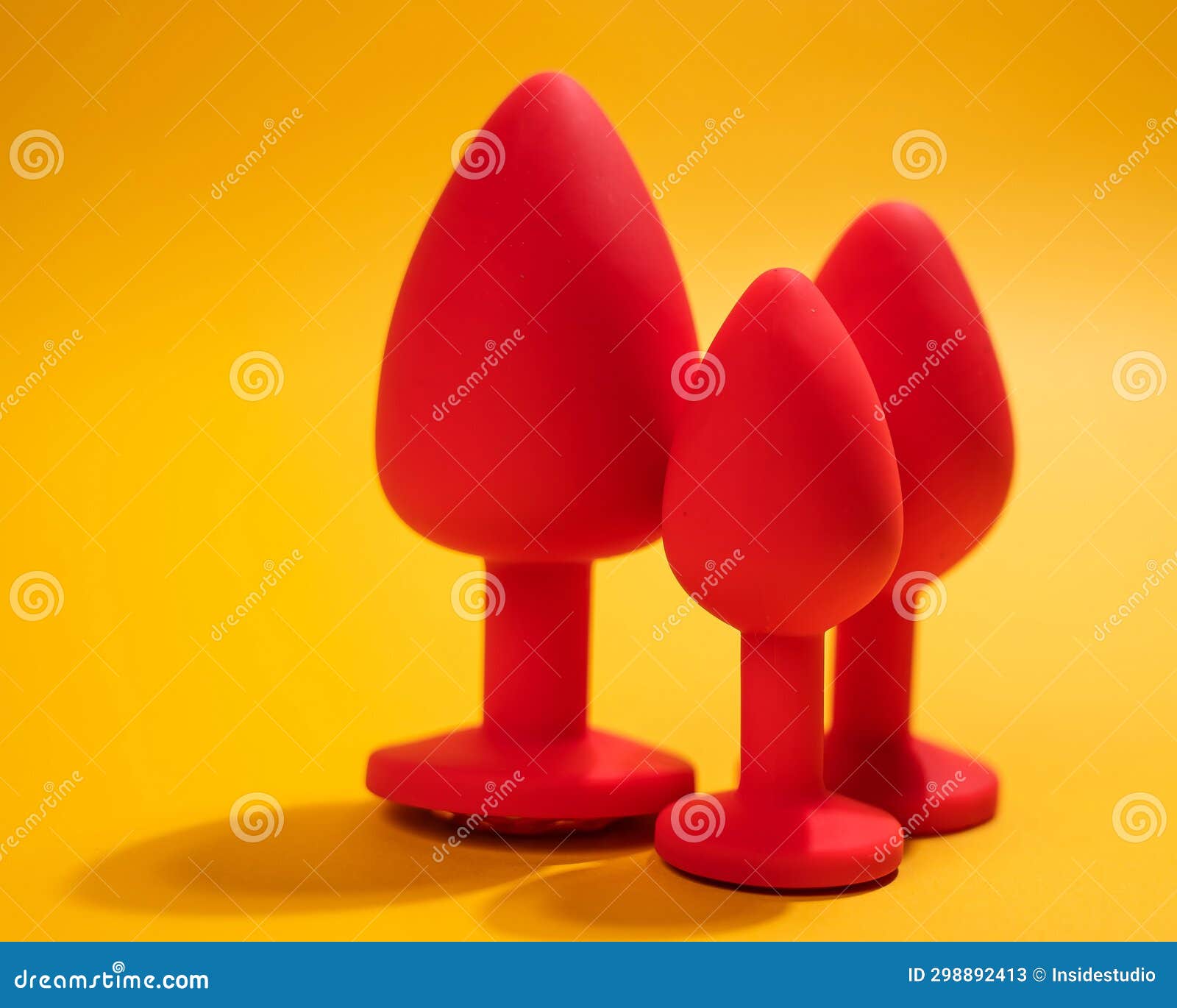 Three Size Silicone Red Plugs on an Orange Background. Stock Image ...