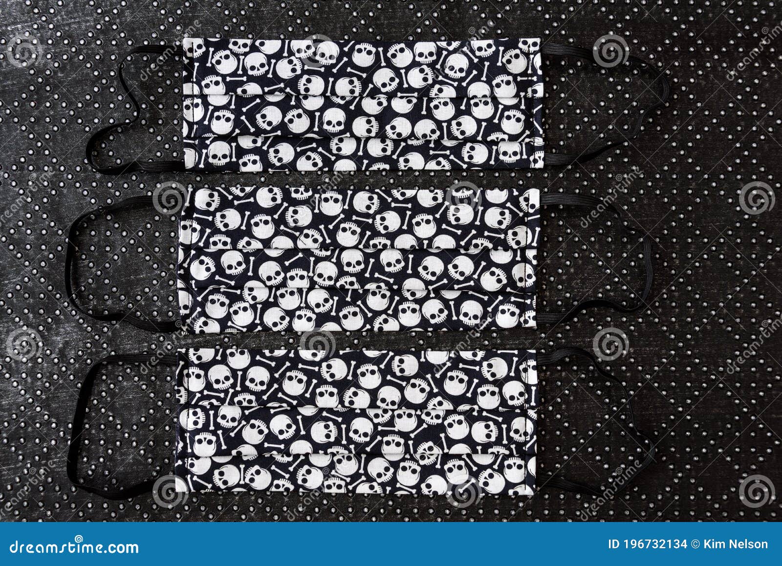 Three Skull and Bones, Black and White Fabric Face Masks on a Black ...