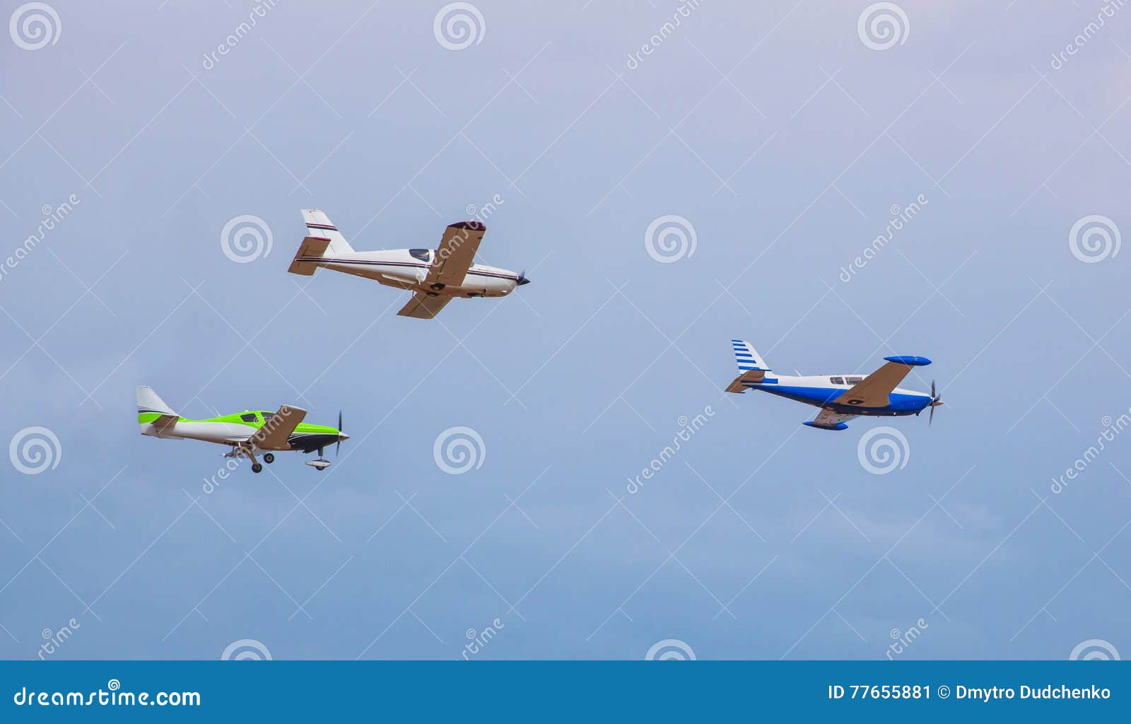 Three Small Aircraft Flying in the Sky Against a Background of Clouds ...