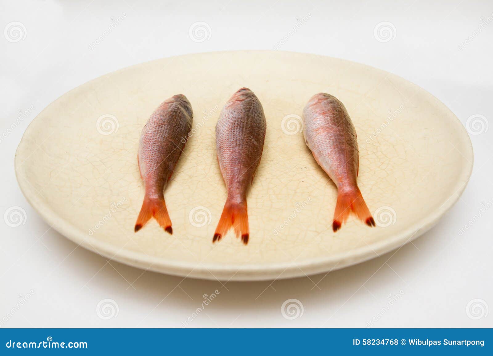 Three small fish on dish stock photo. Image of direction - 58234768