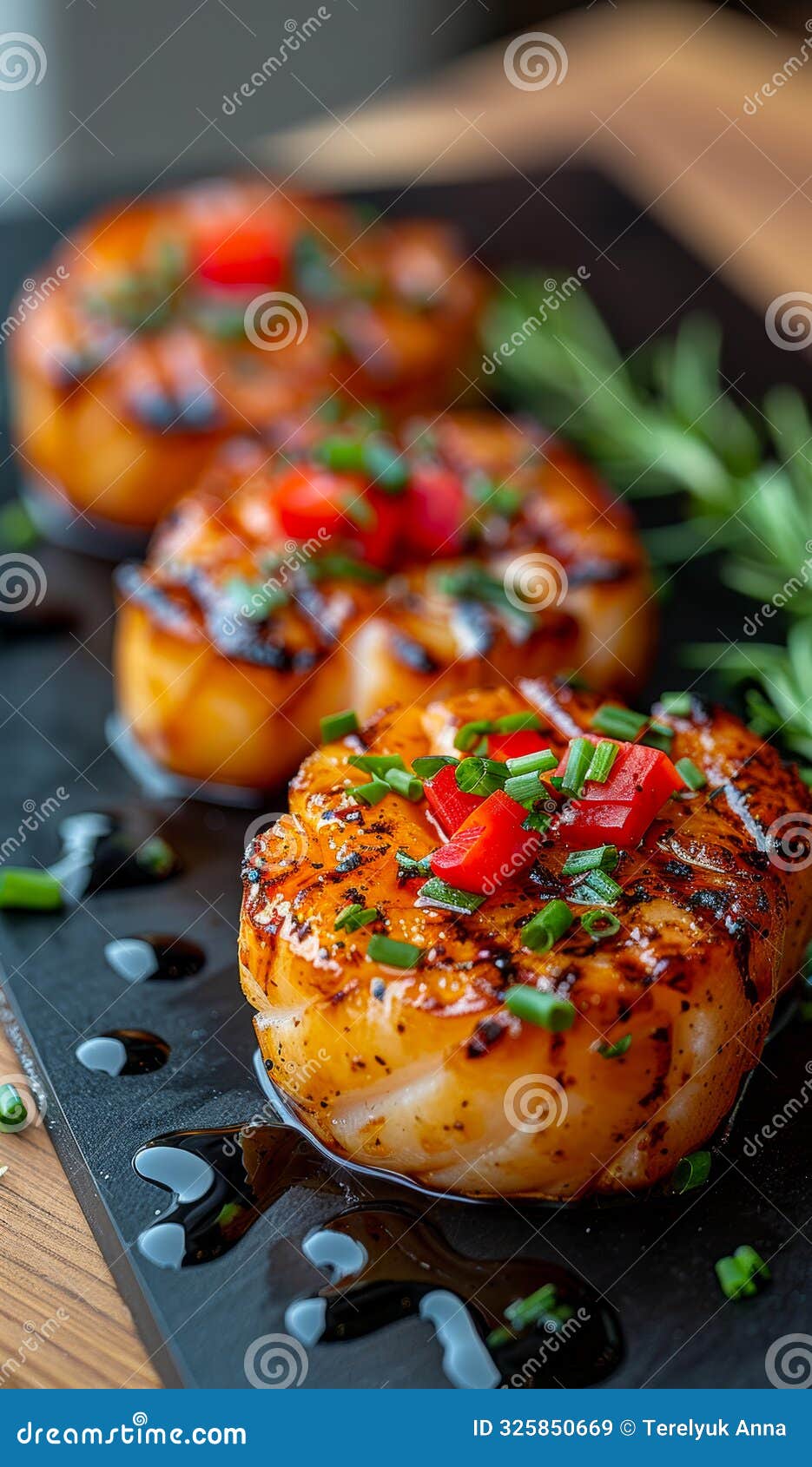 Three Small Shrimp are Sitting on a Black Plate with a Black Table ...