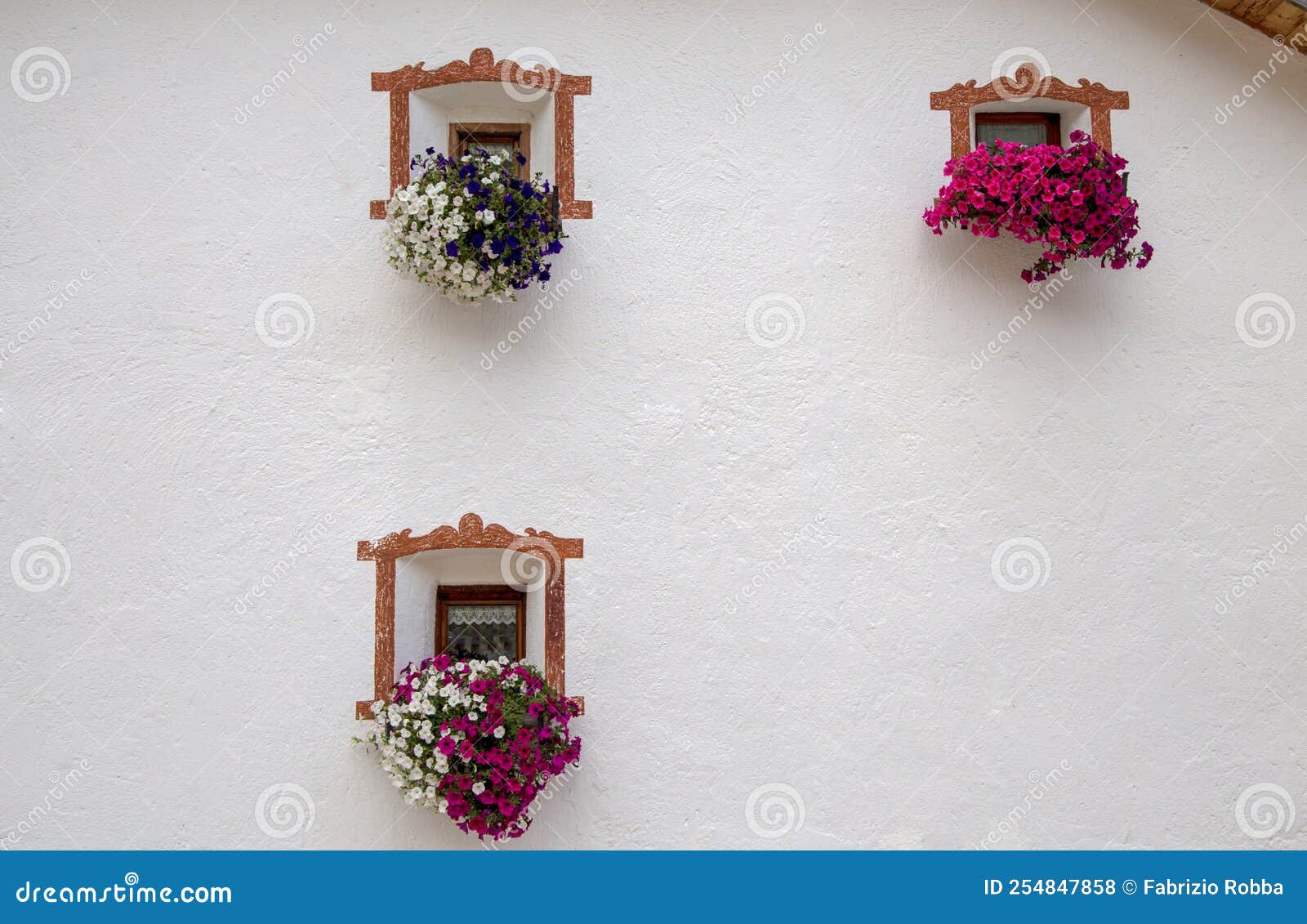 Three Small Windows Decorated with Flowers with a White Facade Stock ...