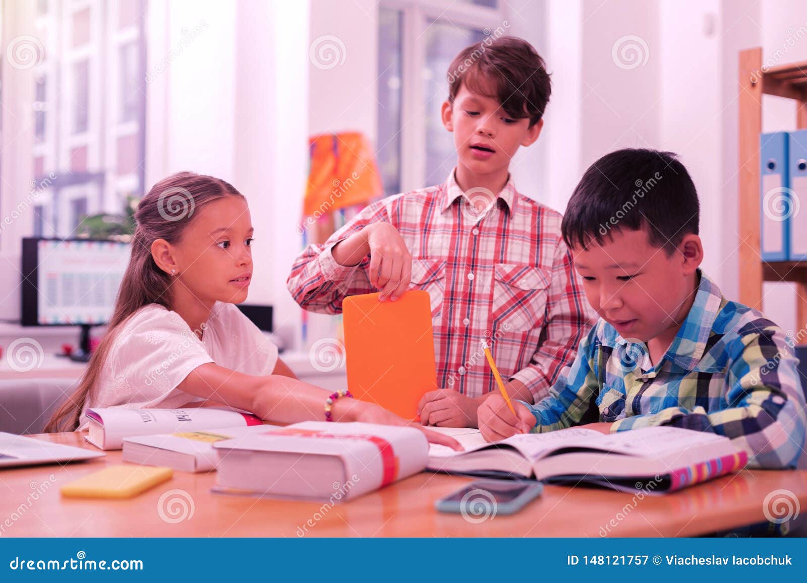 Three Smart Children Making Their Classwork Together. Stock Image ...