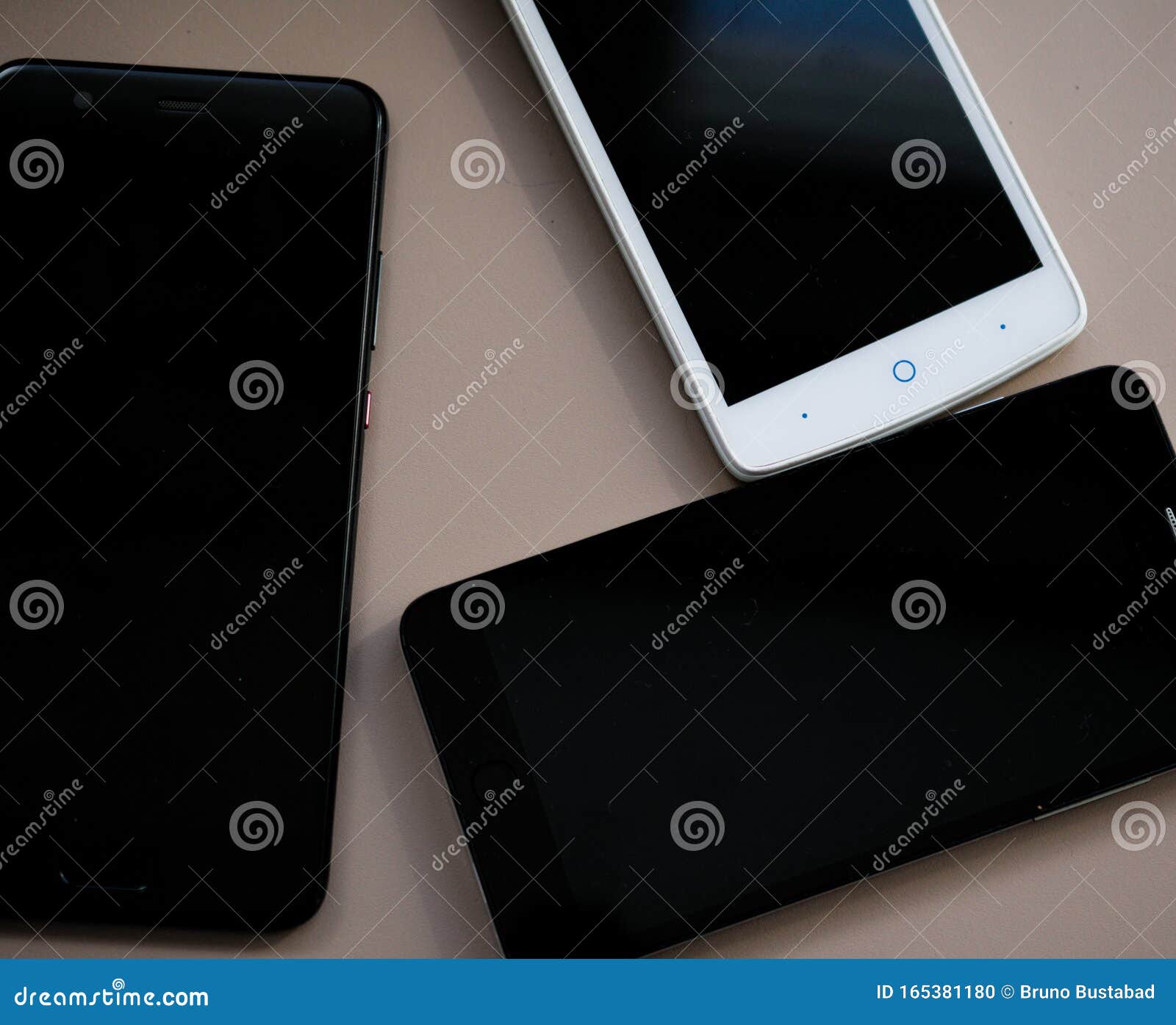 Three Smartphones on a Desk Stock Photo - Image of modern, table: 165381180