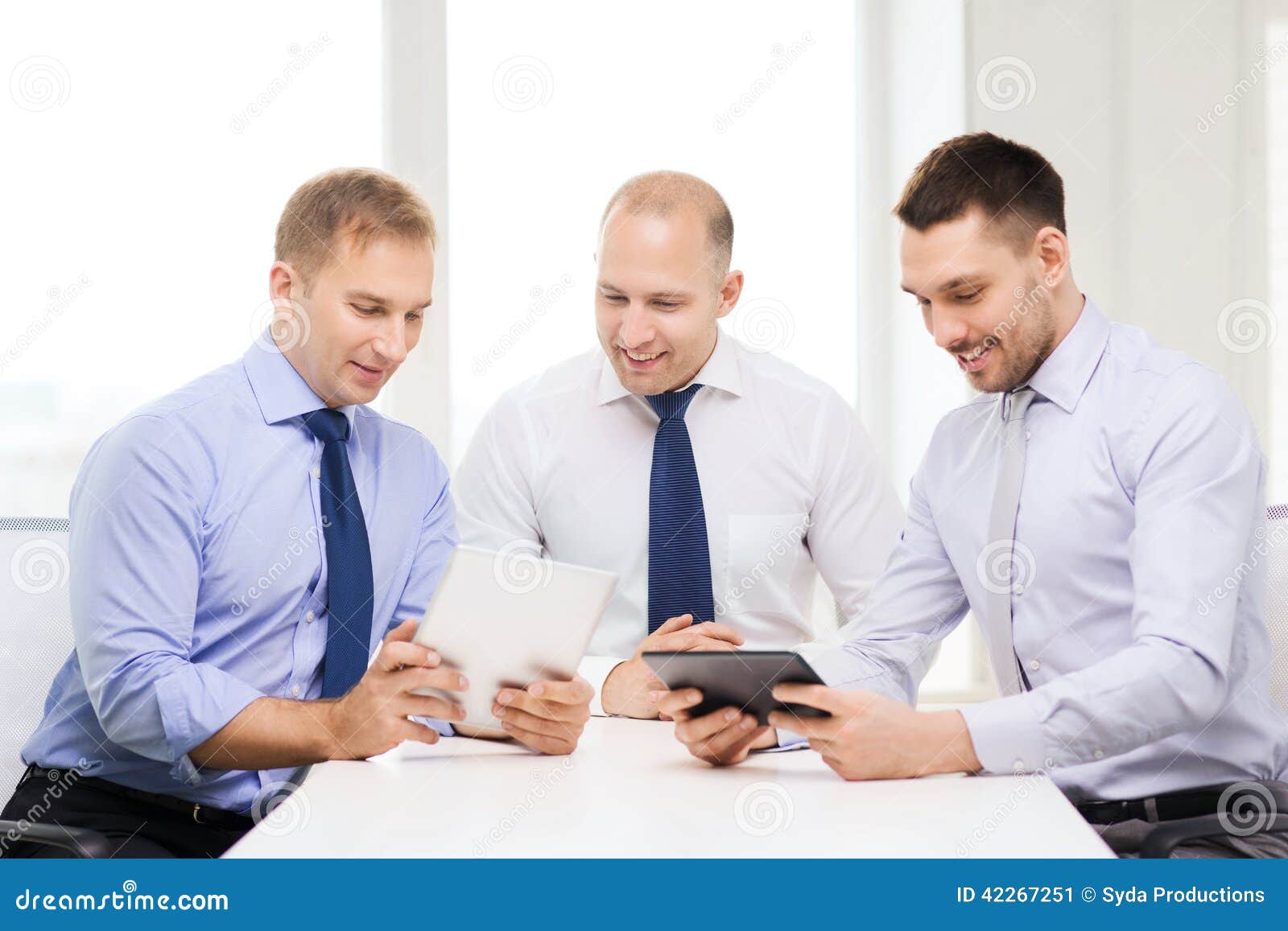 Three Smiling Businessmen with Tablet Pc in Office Stock Image - Image ...