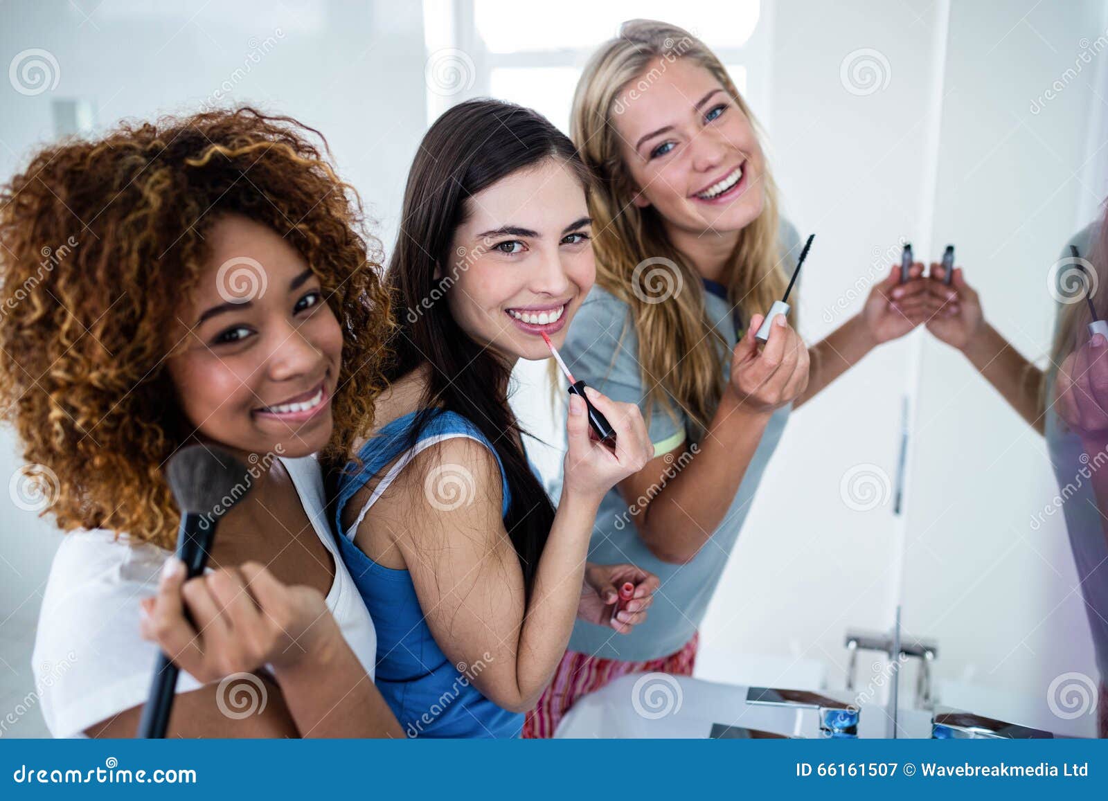 Three Smiling Friends Putting Makeup on Together Stock Image - Image of ...