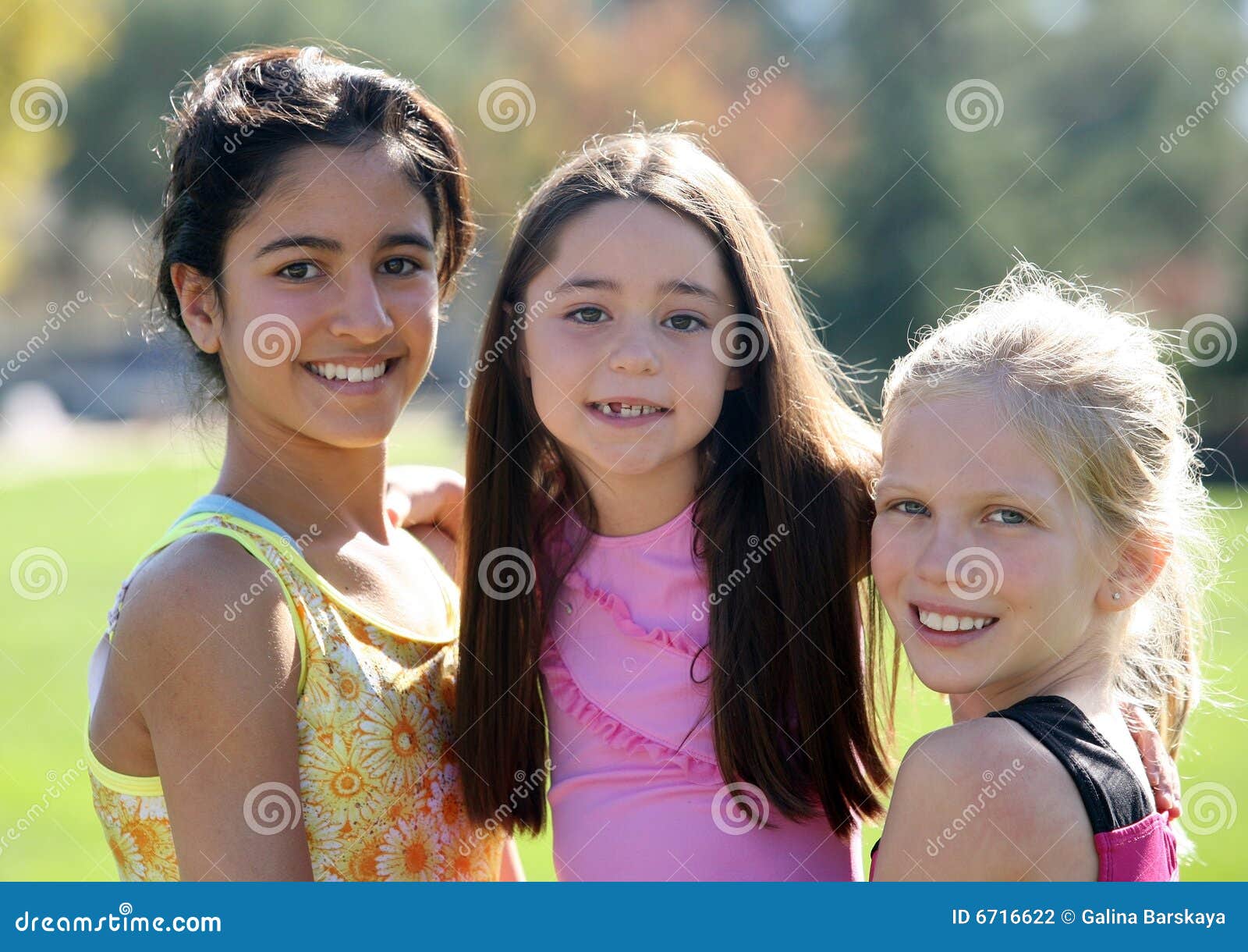 Smiling Girls In Swimwear Holding Glasses With Cocktails While Walking