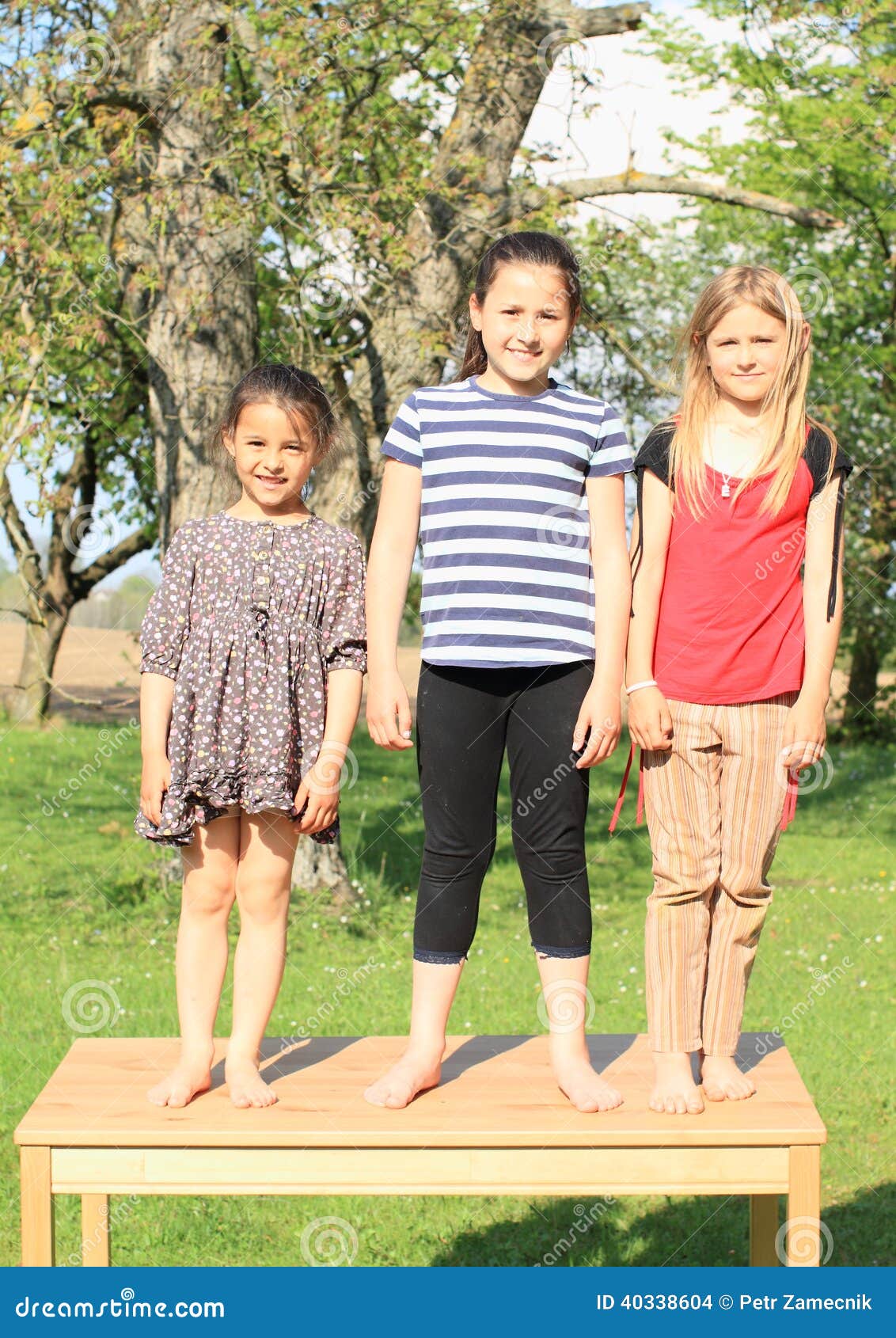 Three Smiling Girls Standing on the Table Stock Photo - Image of friend ...