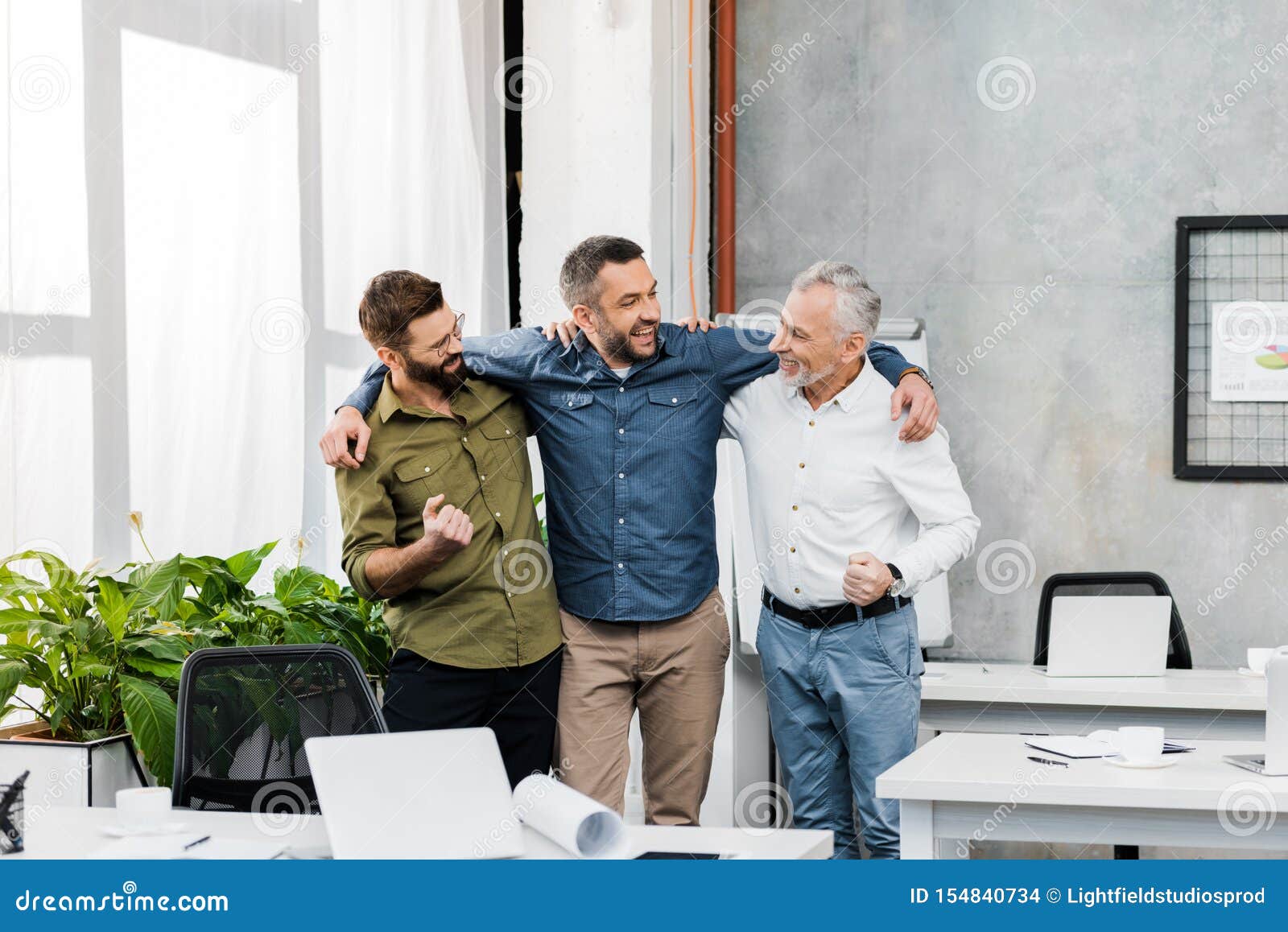 Three Smiling Handsome Businessmen Hugging and Standing Stock Photo ...