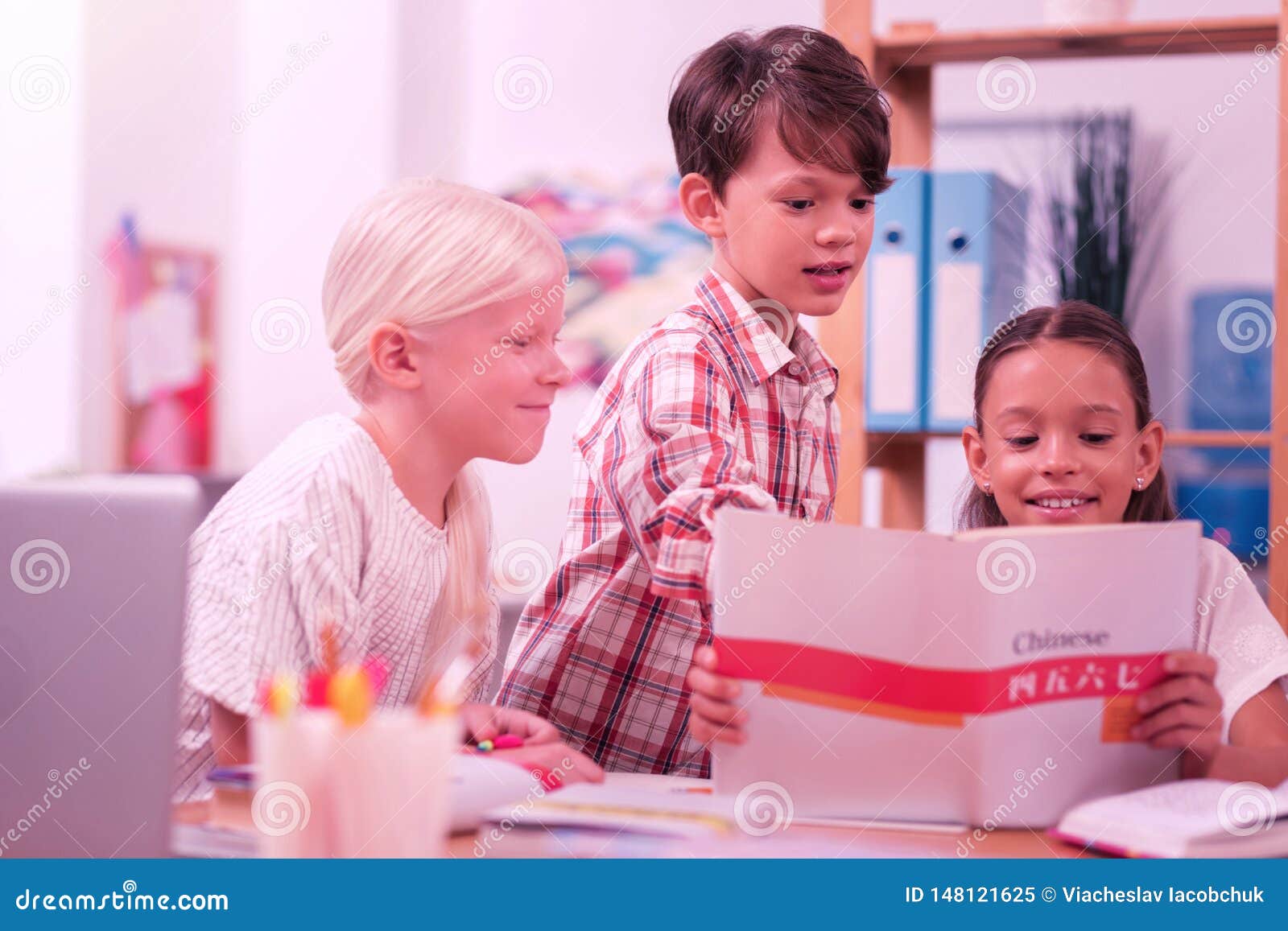 Three Smiling Pupils Learning Chinese in the Classroom. Stock Image ...