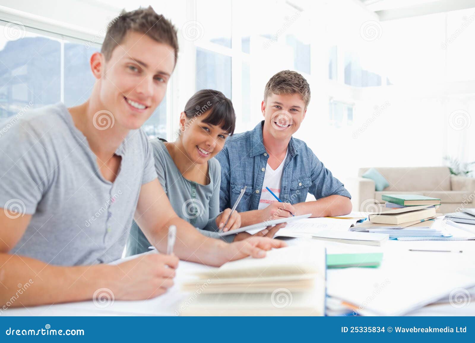 Three Smiling Students Doing Homework As they Look into the Came Stock ...
