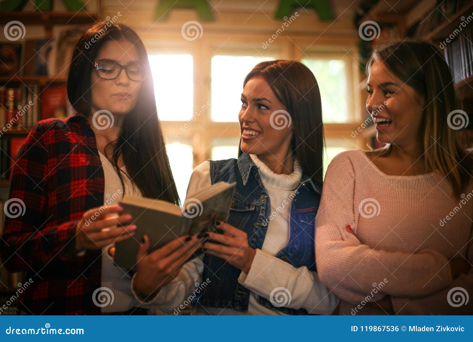 Three Smiling Students Girls Together in Library. Stock Photo - Image ...