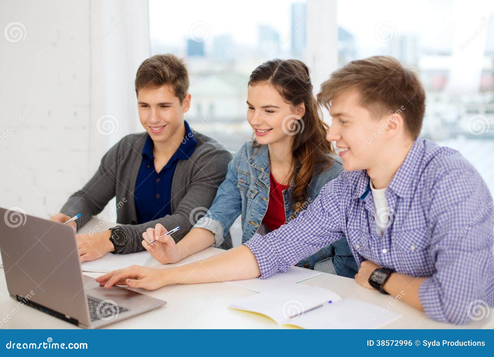 Three Smiling Students with Laptop and Notebooks Stock Photo - Image of ...
