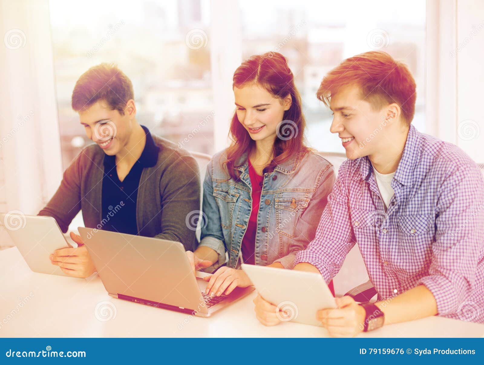 Three Smiling Students with Laptop and Tablet Pc Stock Photo - Image of ...