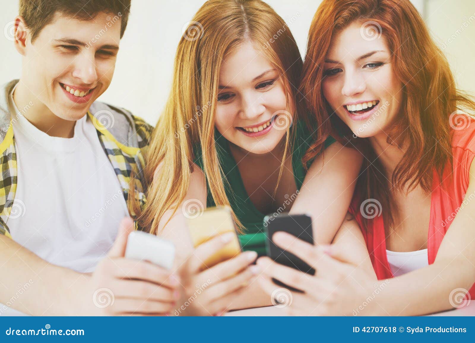 Three Smiling Students with Smartphone at School Stock Photo - Image of ...