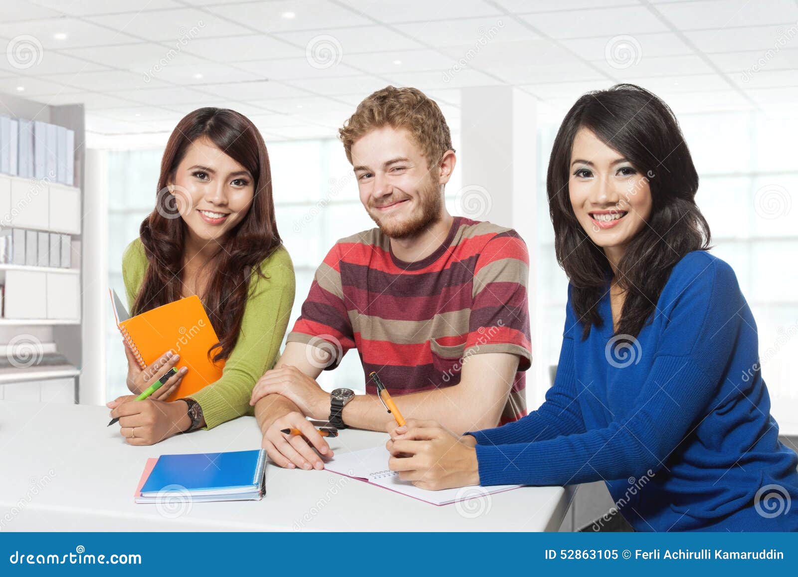 Three Smiling Students Studying Together Stock Image - Image of ...