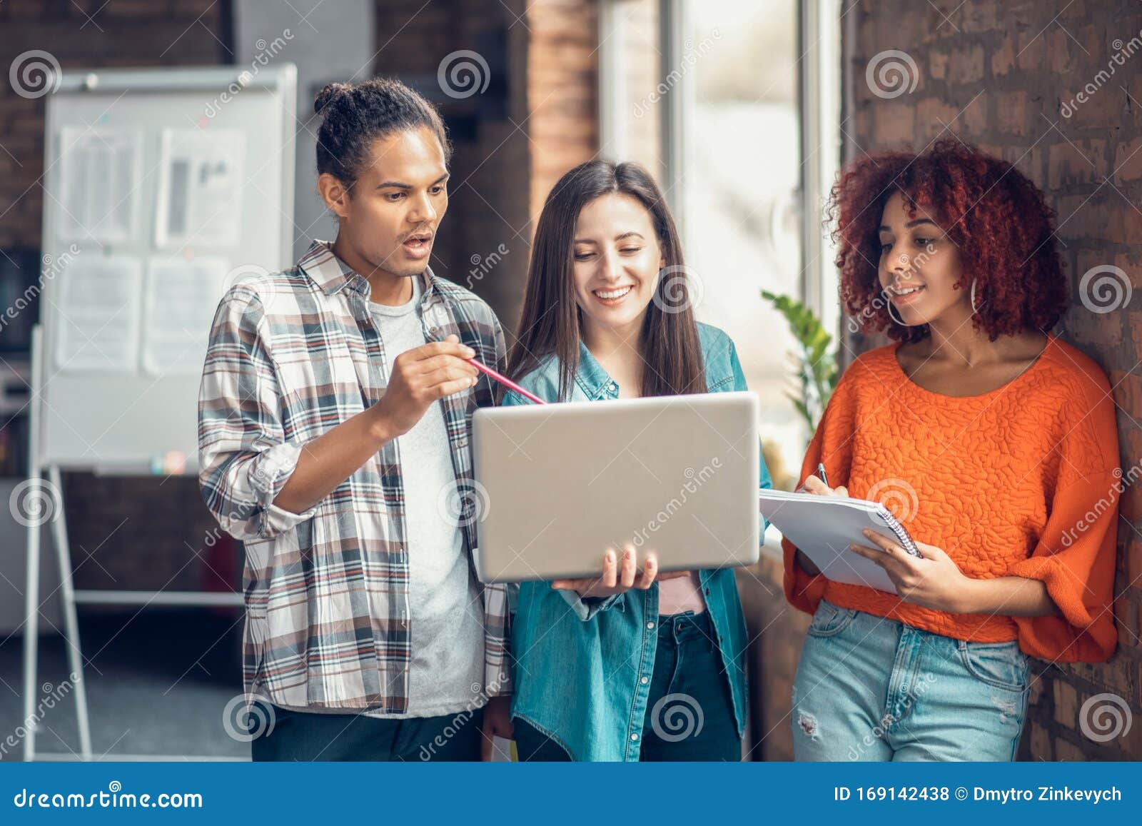 Three Smiling Students Watching Webinar and Studying Together Stock ...
