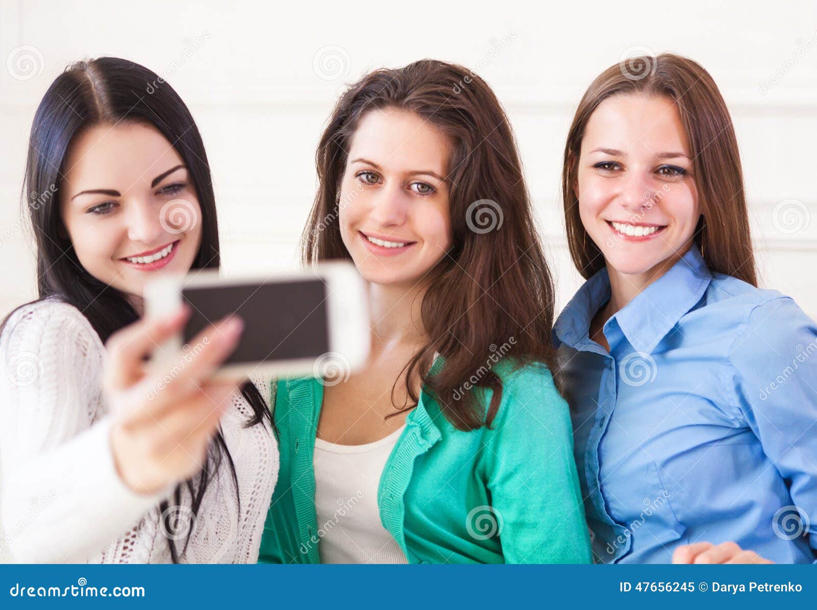Three Smiling Teenage Girls Taking Selfie With Smartphone Camera Stock