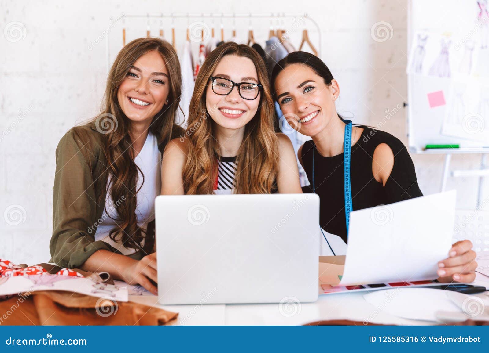 Three Smiling Young Women Clothes Designers Working Stock Photo - Image ... Three Smiling Young Women Clothes Designers Working Stock Photo - Image ...