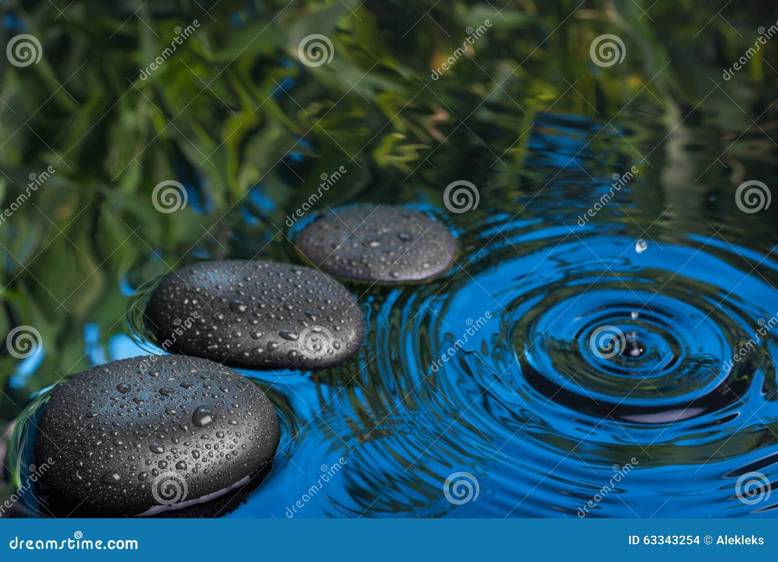 Three Spa Stone Drops Lie in the Blue Water Stock Photo - Image of ...