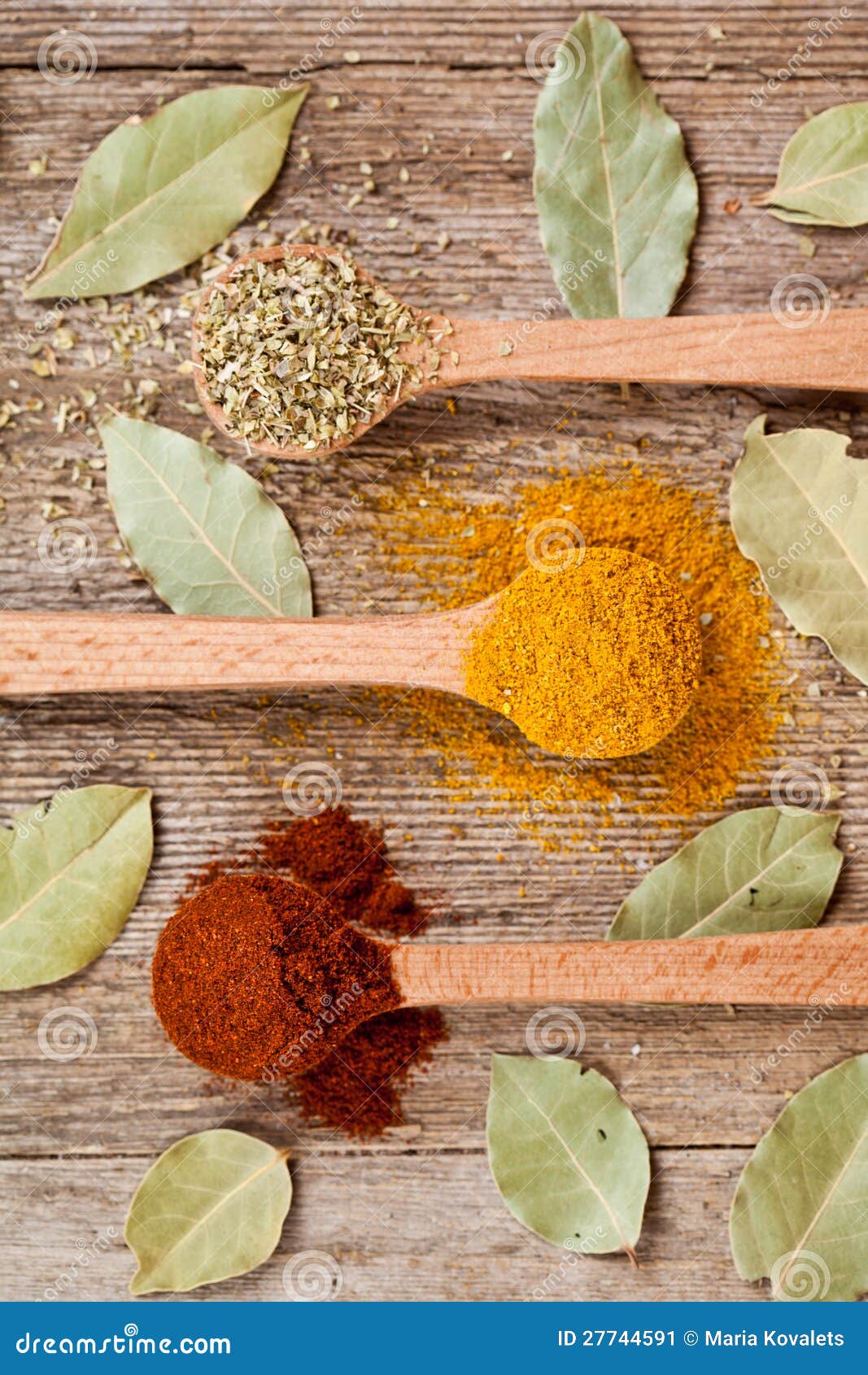 Three Spices in Wooden Spoons and Bay Leaves Stock Image - Image of ...
