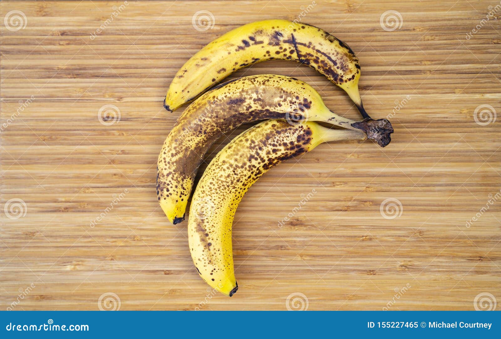 Three Spotted Ripe Bananas on a Wooden Surface Stock Image - Image of ...