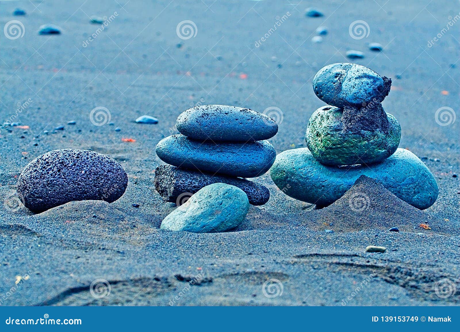 Three Stacked Balanced Stones or Pebbles on Black Volcanic Sand Stock ...