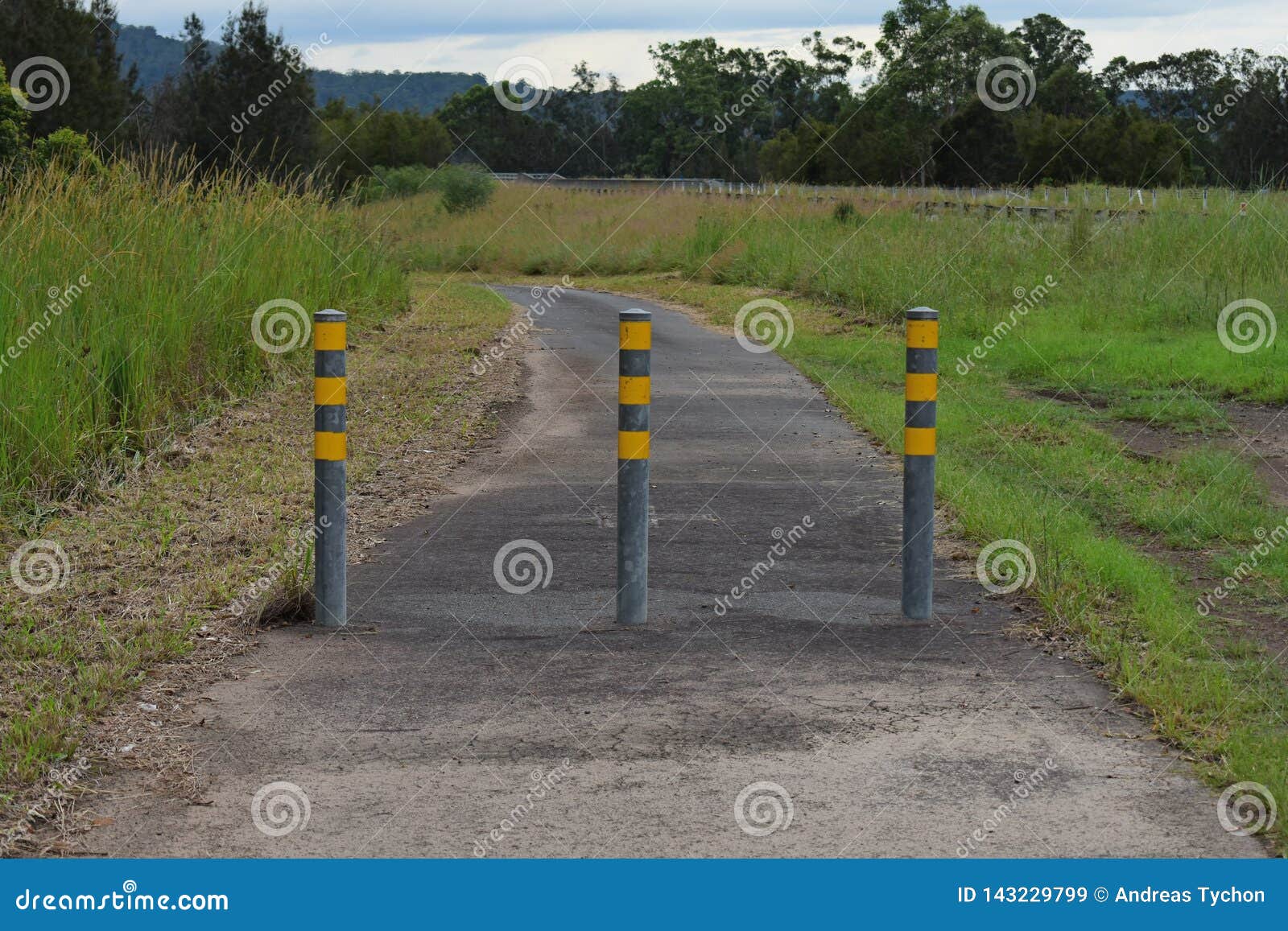 Three Steels Posts Blocking a Single Lane Road Stock Image - Image of ...