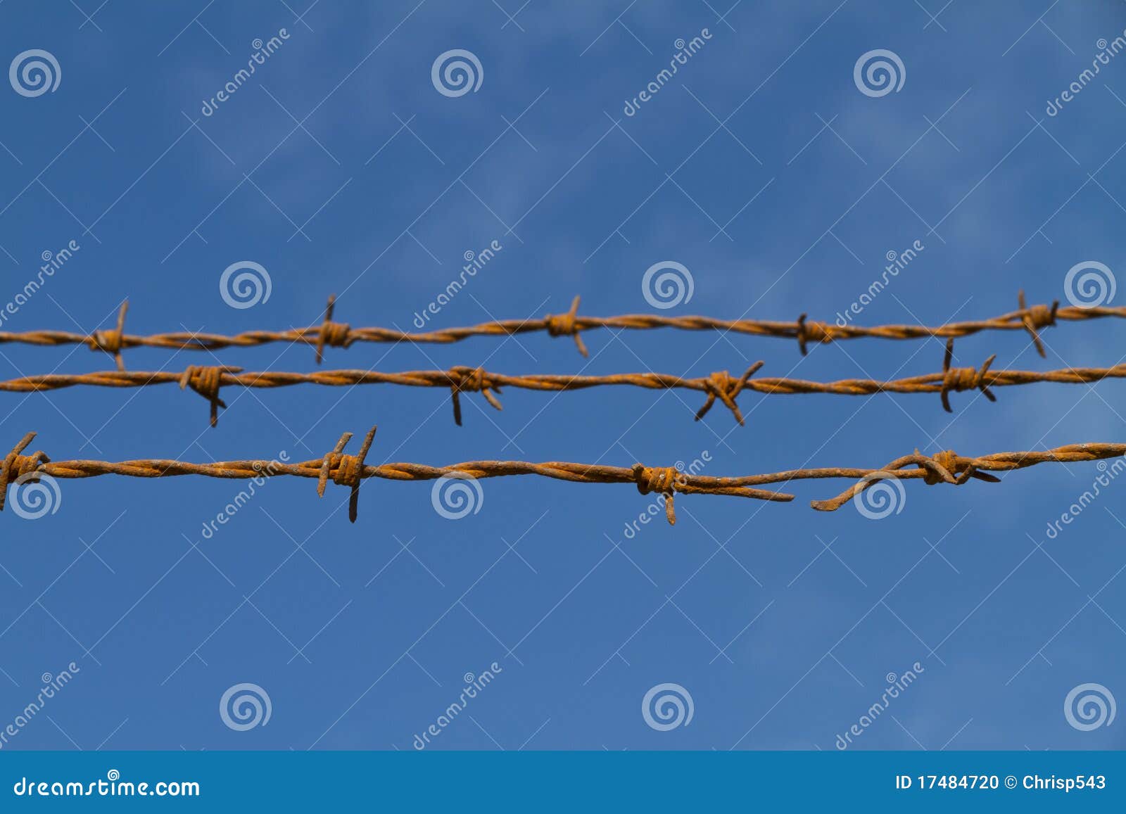 Three Strands Of Barbed Wire Lying Loosely On A Fence Of Old Concrete ...