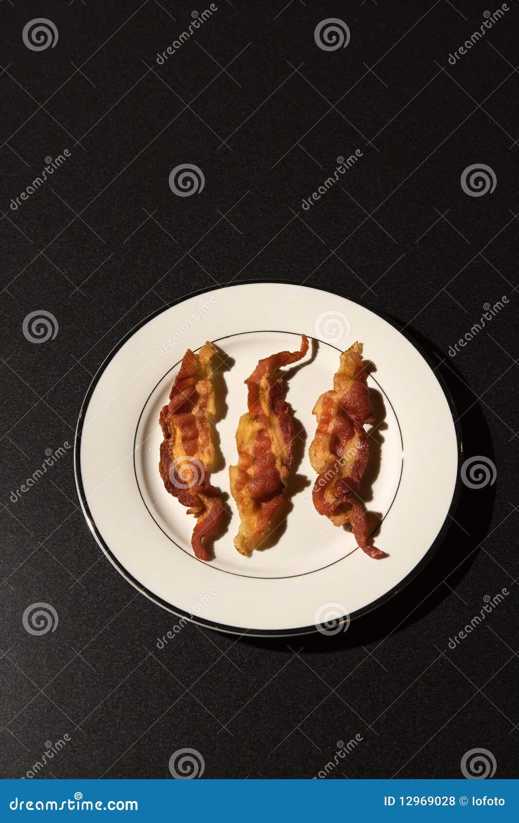 Three Strips of Cooked Bacon on White Plate Stock Photo - Image of ...