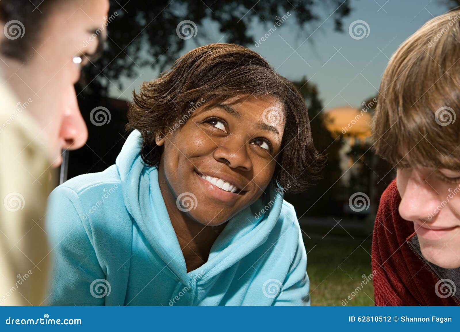 Three students stock photo. Image of lawn, head, people - 62810512