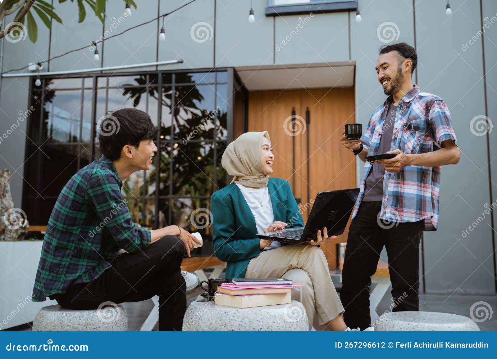 Three Students Chatting Doing Assignments in Front of the Building ...