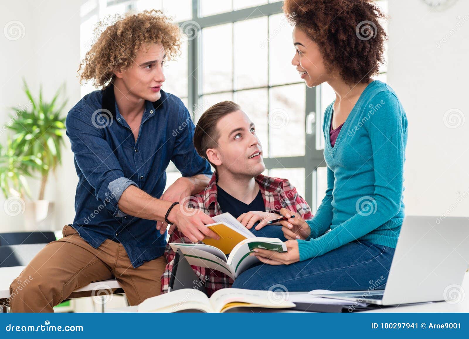 Three Students Comparing Information from Two Different Textbook Stock ...